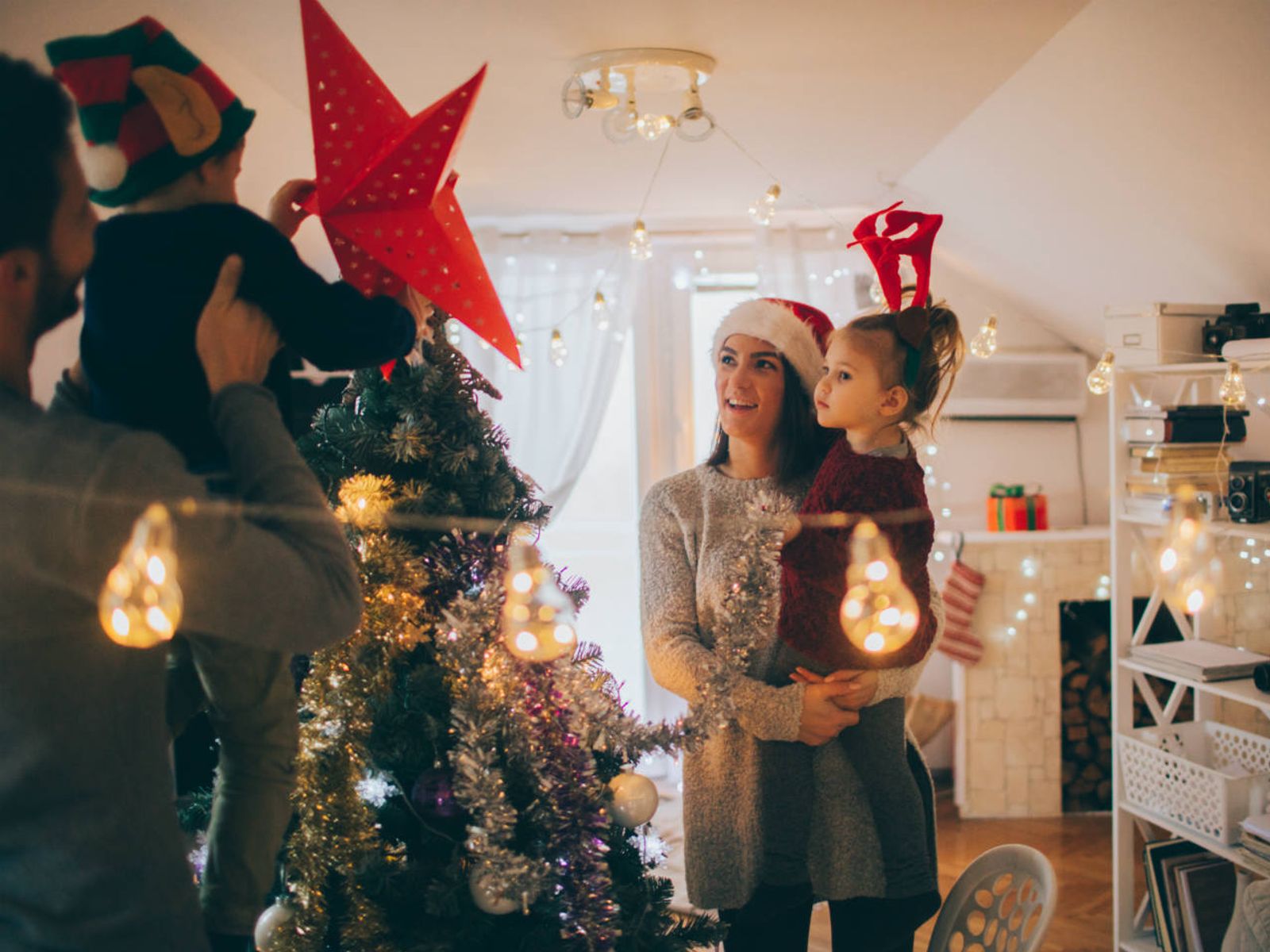 Parents Relaxing After Christmas Parents Carrying Children Decorating
