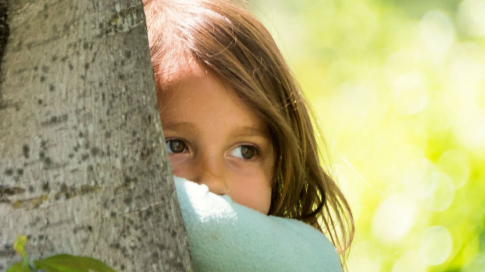 Child Hiding Behind Parent